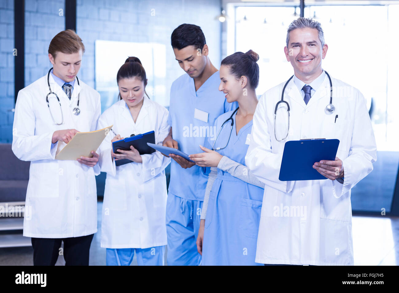 Doctors examining medical report Stock Photo - Alamy