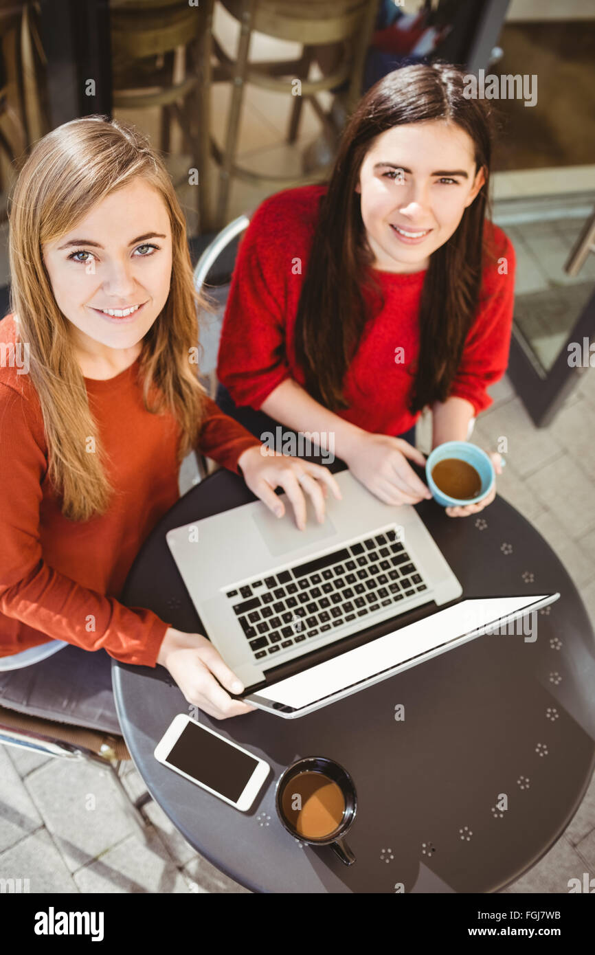 Friends using laptop together Stock Photo - Alamy