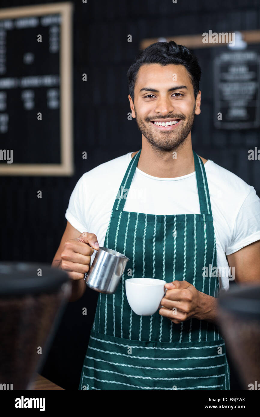 Handsome waiter serving coffee cup Stock Photo - Alamy