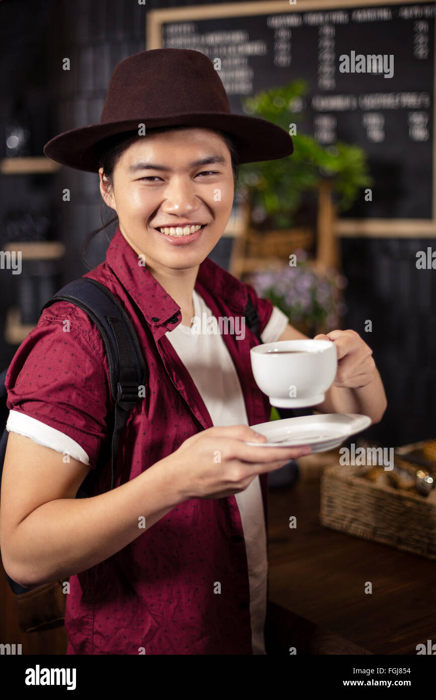 Happy customer drinking coffee Stock Photo - Alamy