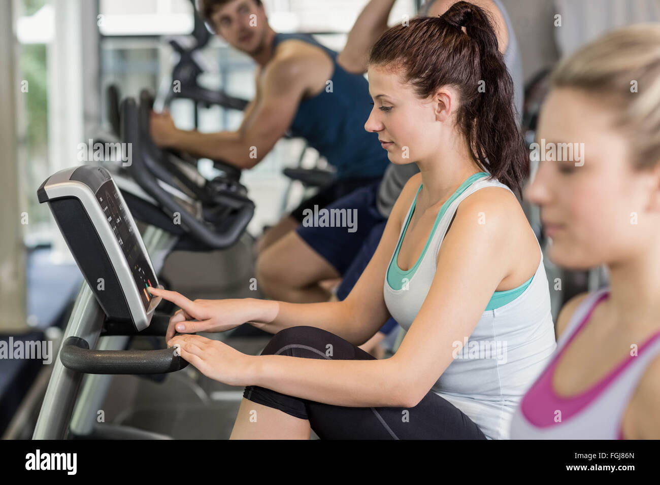 Fit people doing exercise bike Stock Photo - Alamy