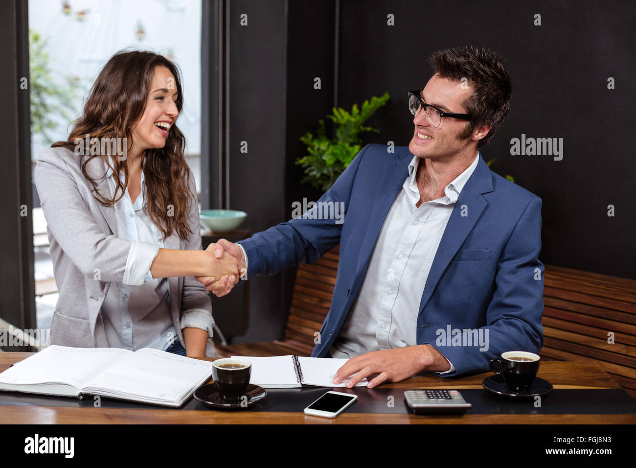 People giving handshake Stock Photo - Alamy