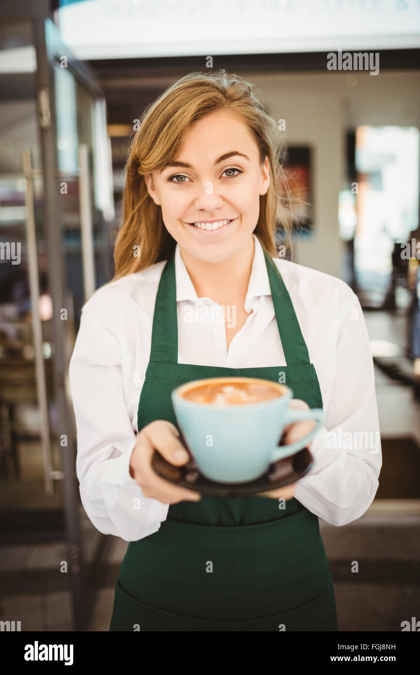 Waitress serving a cup of coffee Stock Photo - Alamy