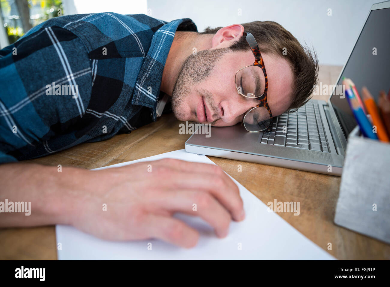Handsome man sleeping on laptop Stock Photo - Alamy