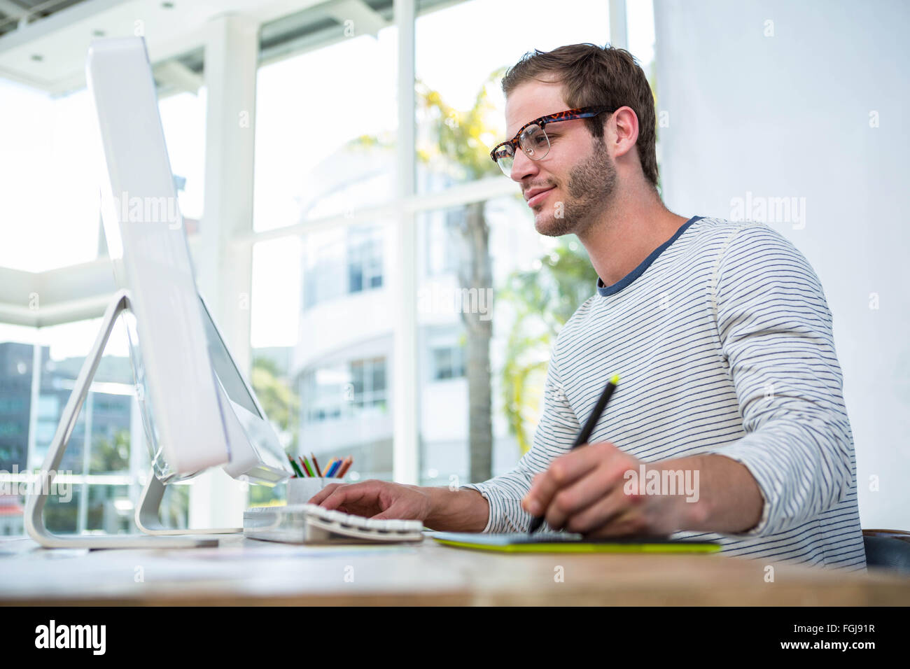 Handsome man working on computer Stock Photo - Alamy