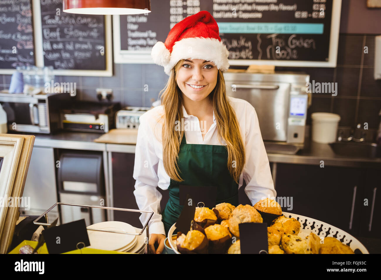 Cute waitress standing behind the counter Stock Photo - Alamy