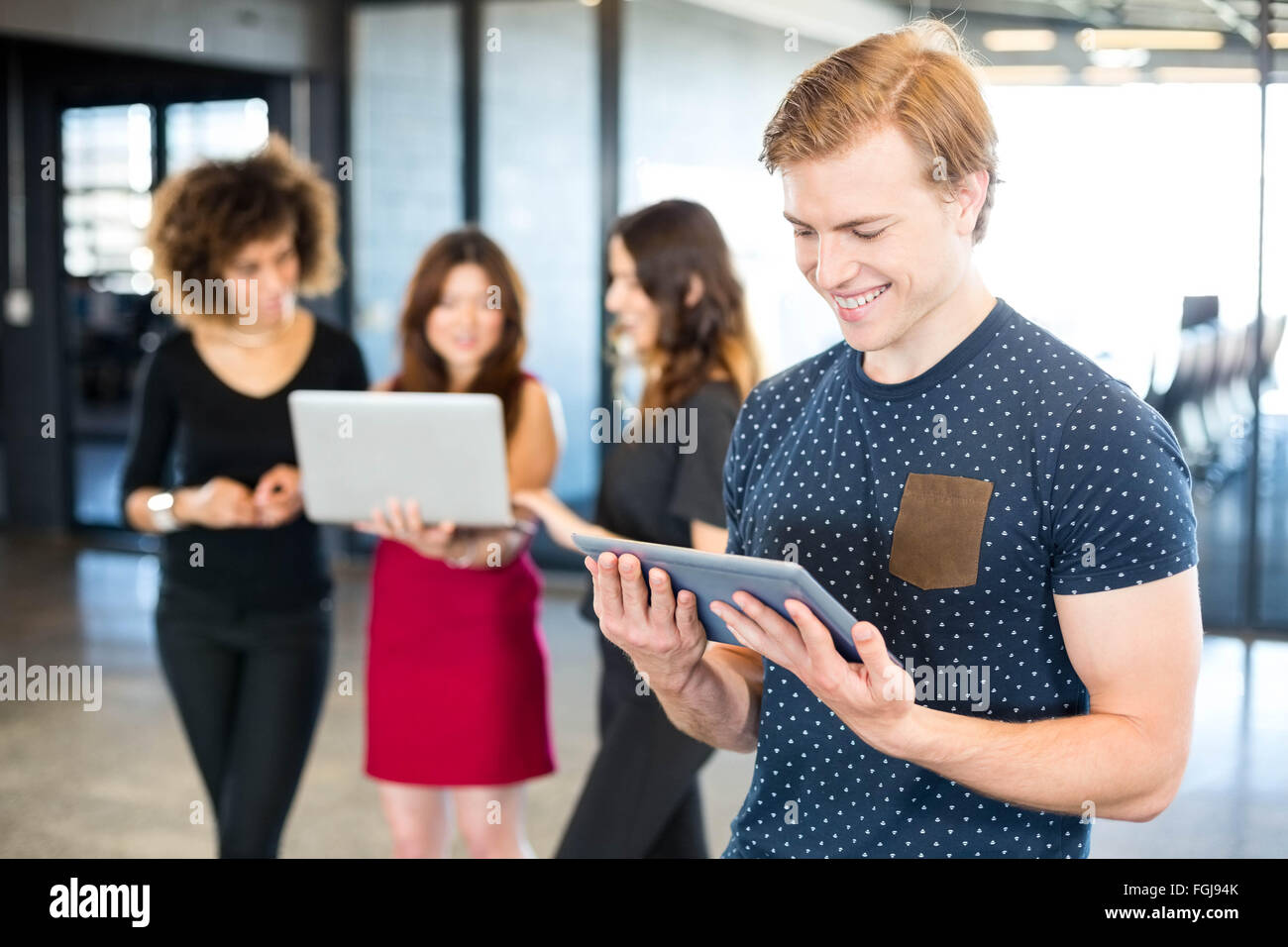 Man looking at digital tablet and smiling Stock Photo - Alamy