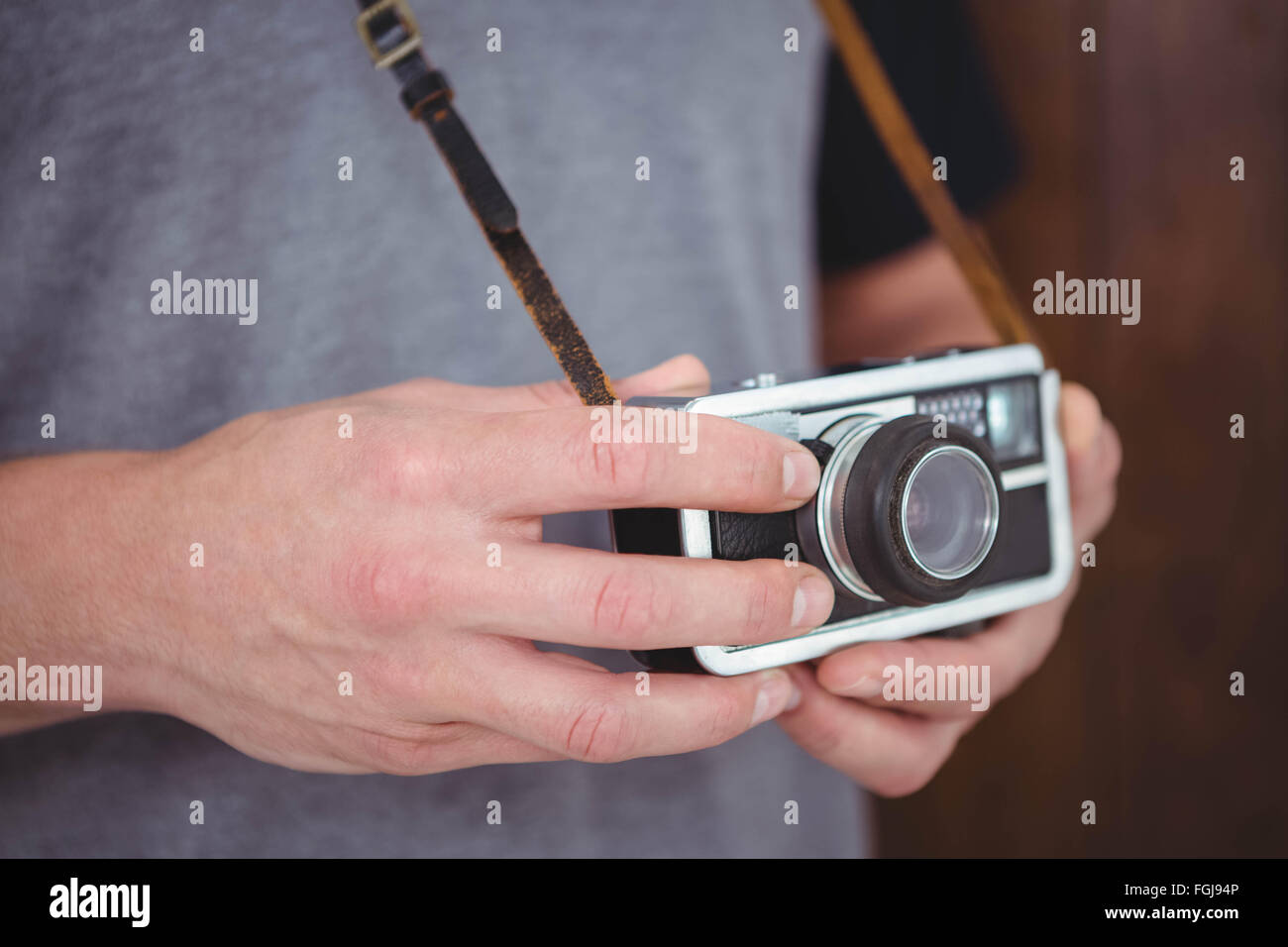 Handsome hipster holding retro camera Stock Photo - Alamy