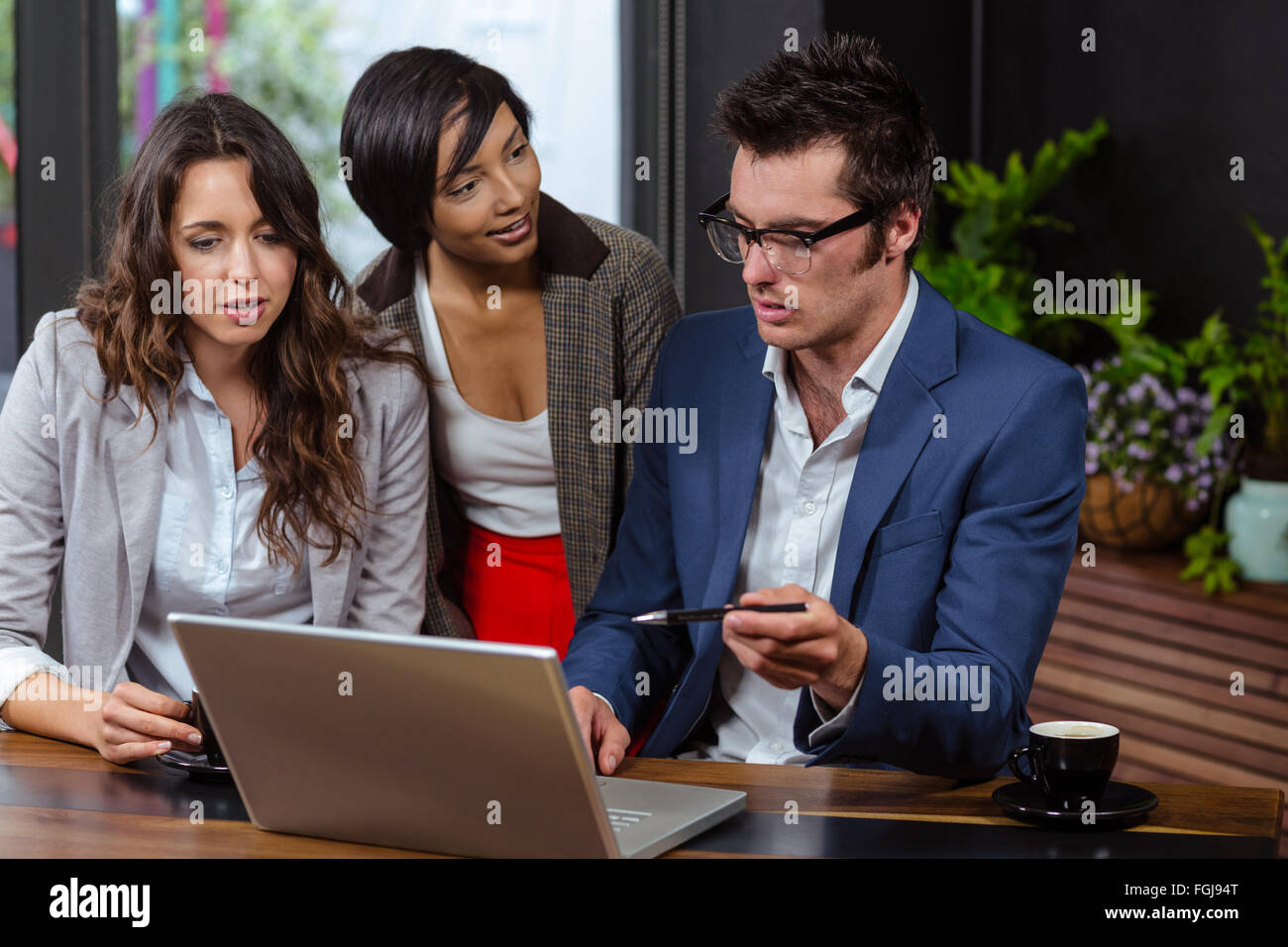 People using laptop together Stock Photo - Alamy