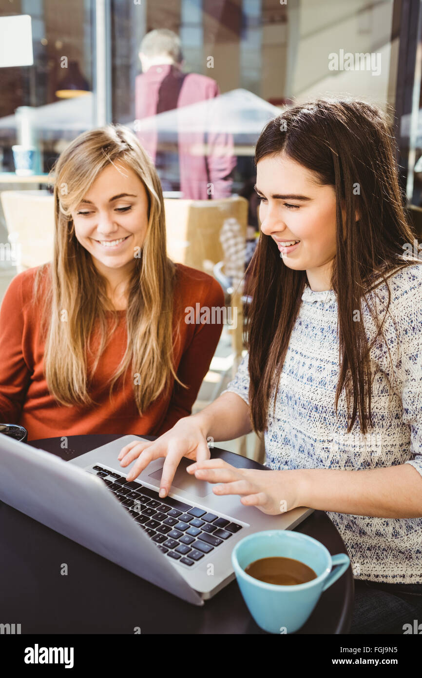 Friends using laptop together Stock Photo - Alamy