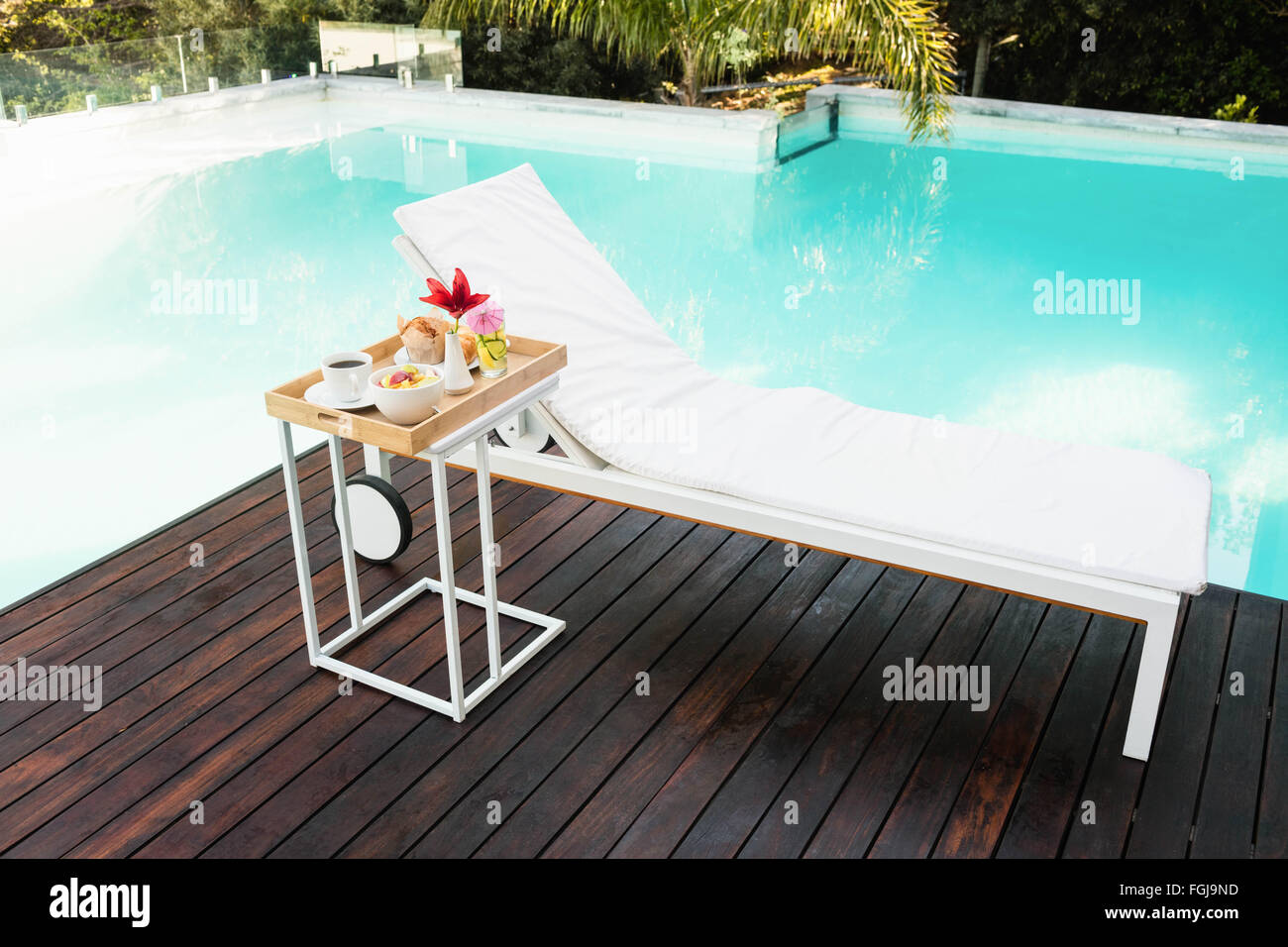 Tray with breakfast in side table and sun lounger Stock Photo - Alamy