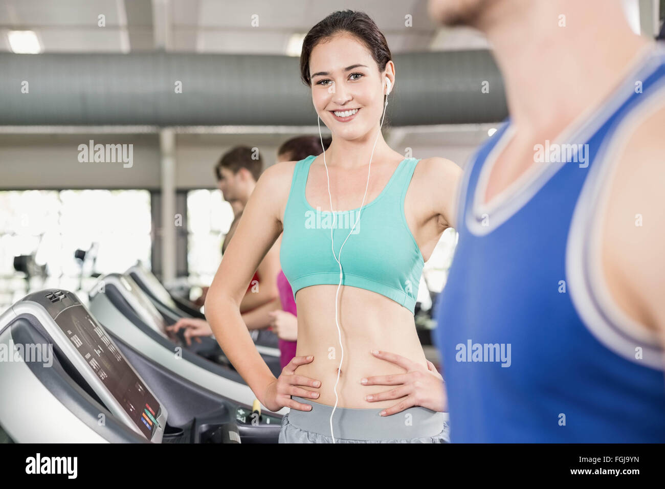 Fit woman running on treadmill Stock Photo - Alamy