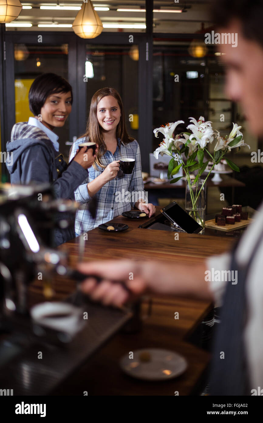 Smiling women having coffee Stock Photo - Alamy