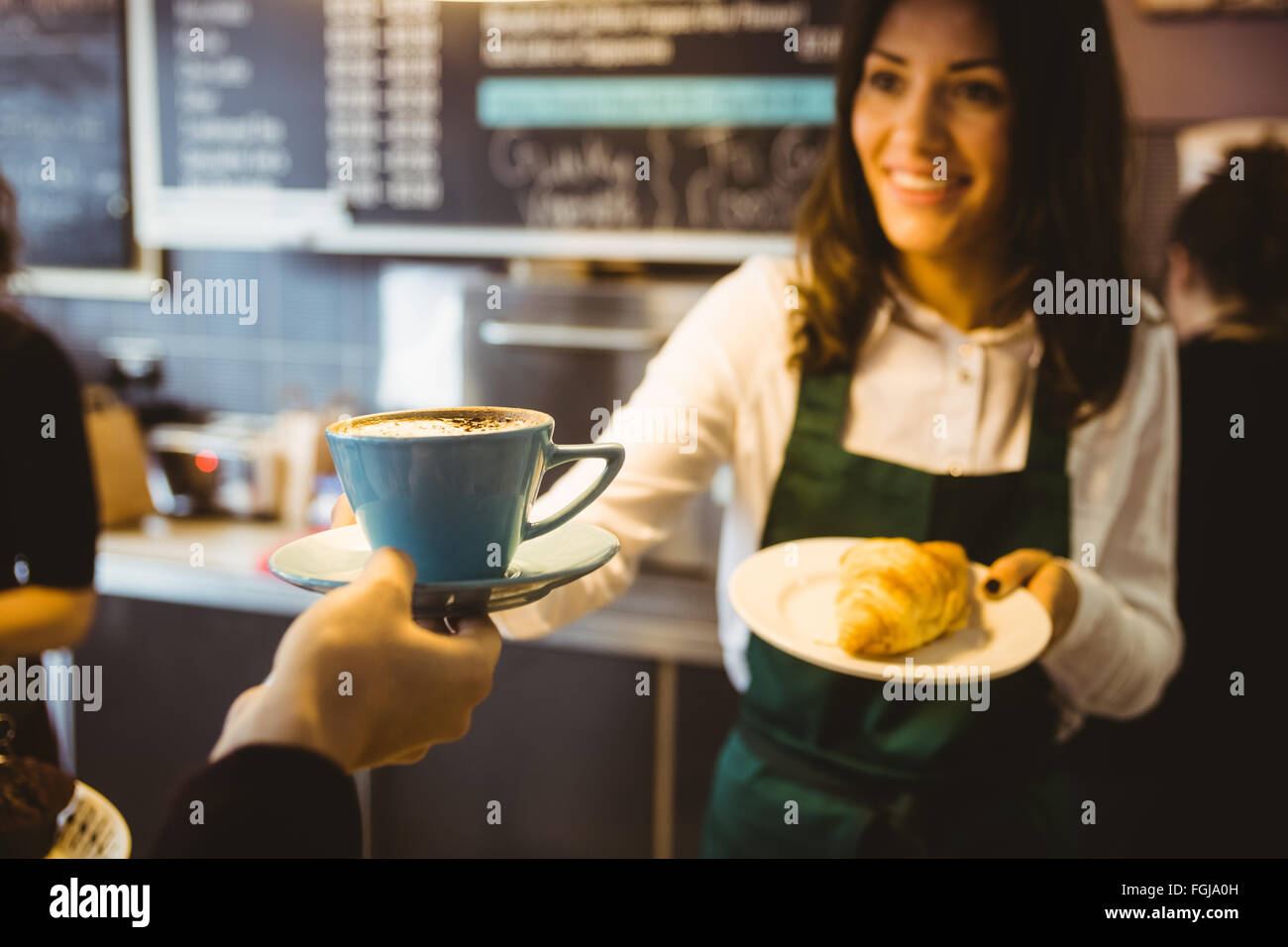 Waitress serving a cup of coffee Stock Photo - Alamy