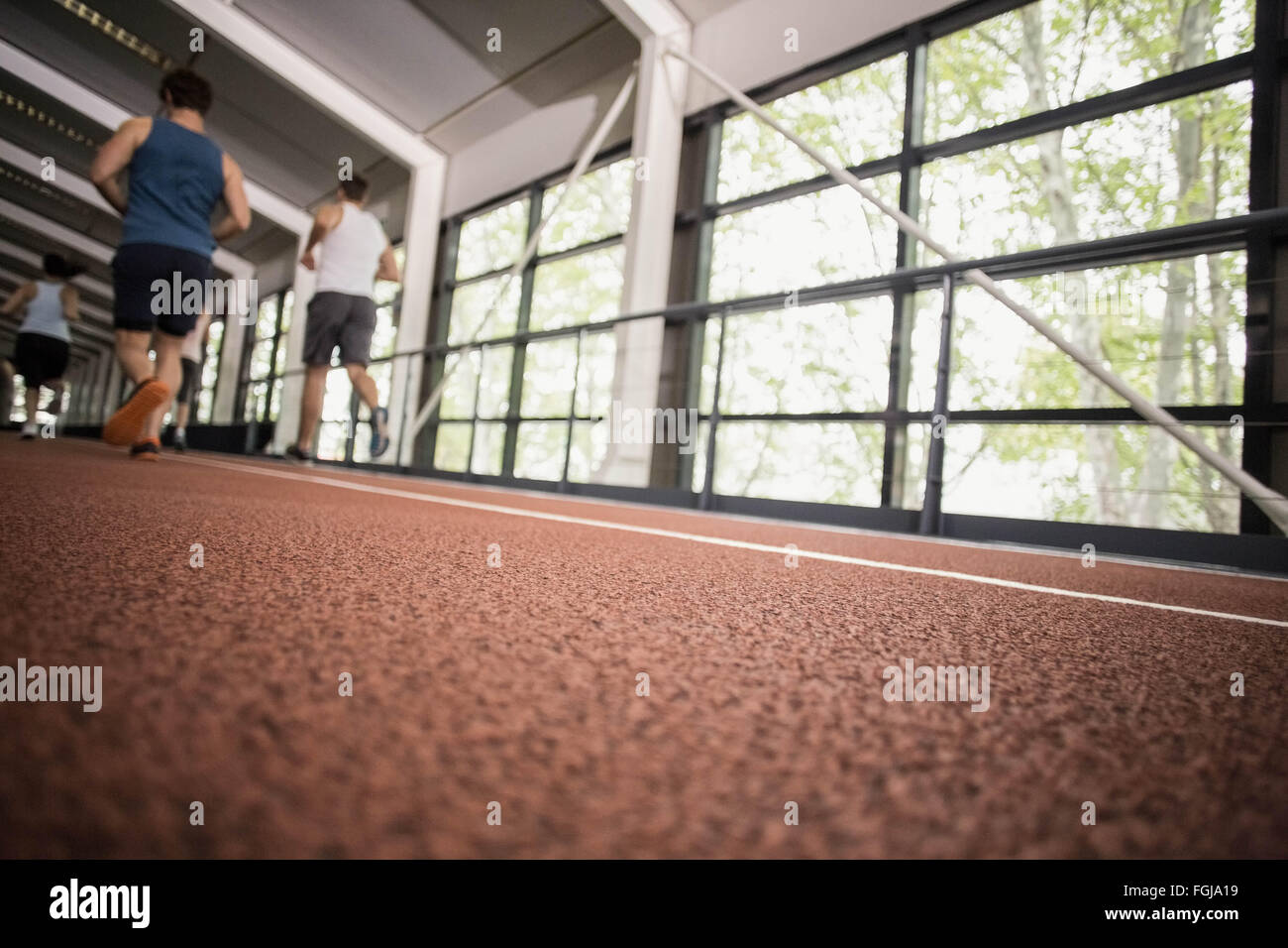 Four athletic women and men running Stock Photo - Alamy