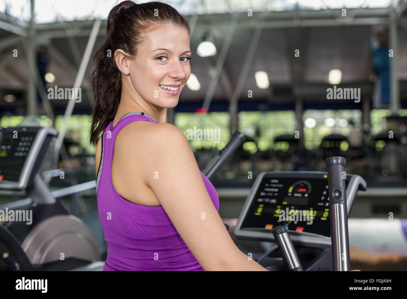 Fit woman on elliptical bike Stock Photo - Alamy