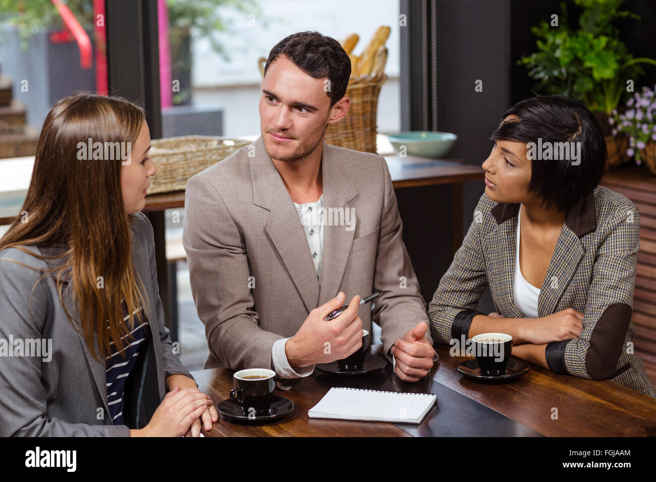 Friends writing in a notebook Stock Photo - Alamy