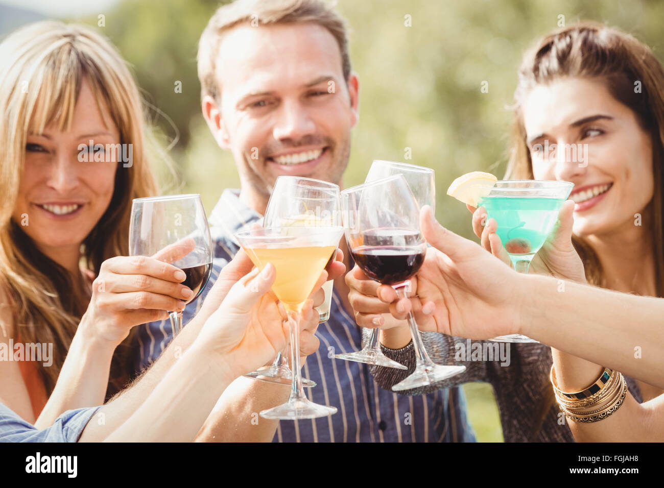 Happy young friends having drinks Stock Photo - Alamy