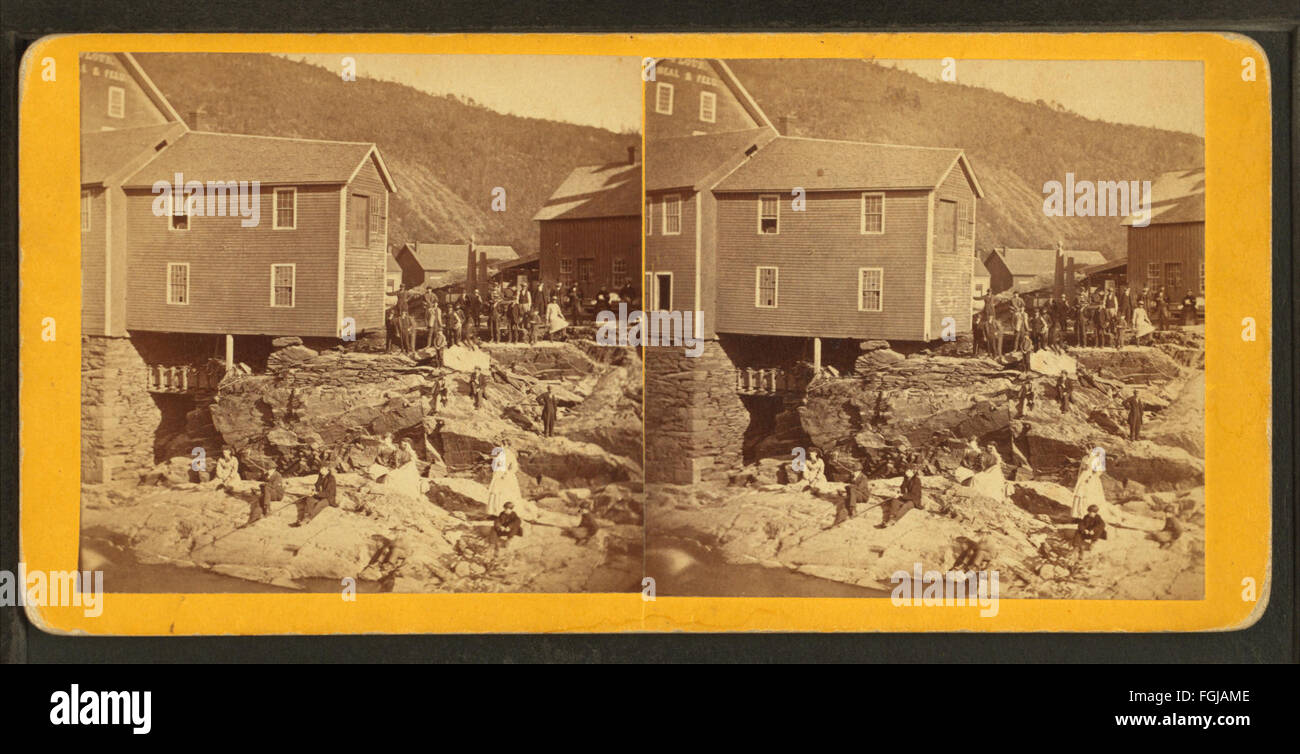This photograph by Caleb L. Howe captures people standing on rocks near ...