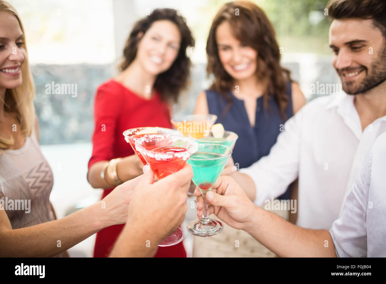 Group of friends having cocktail Stock Photo - Alamy