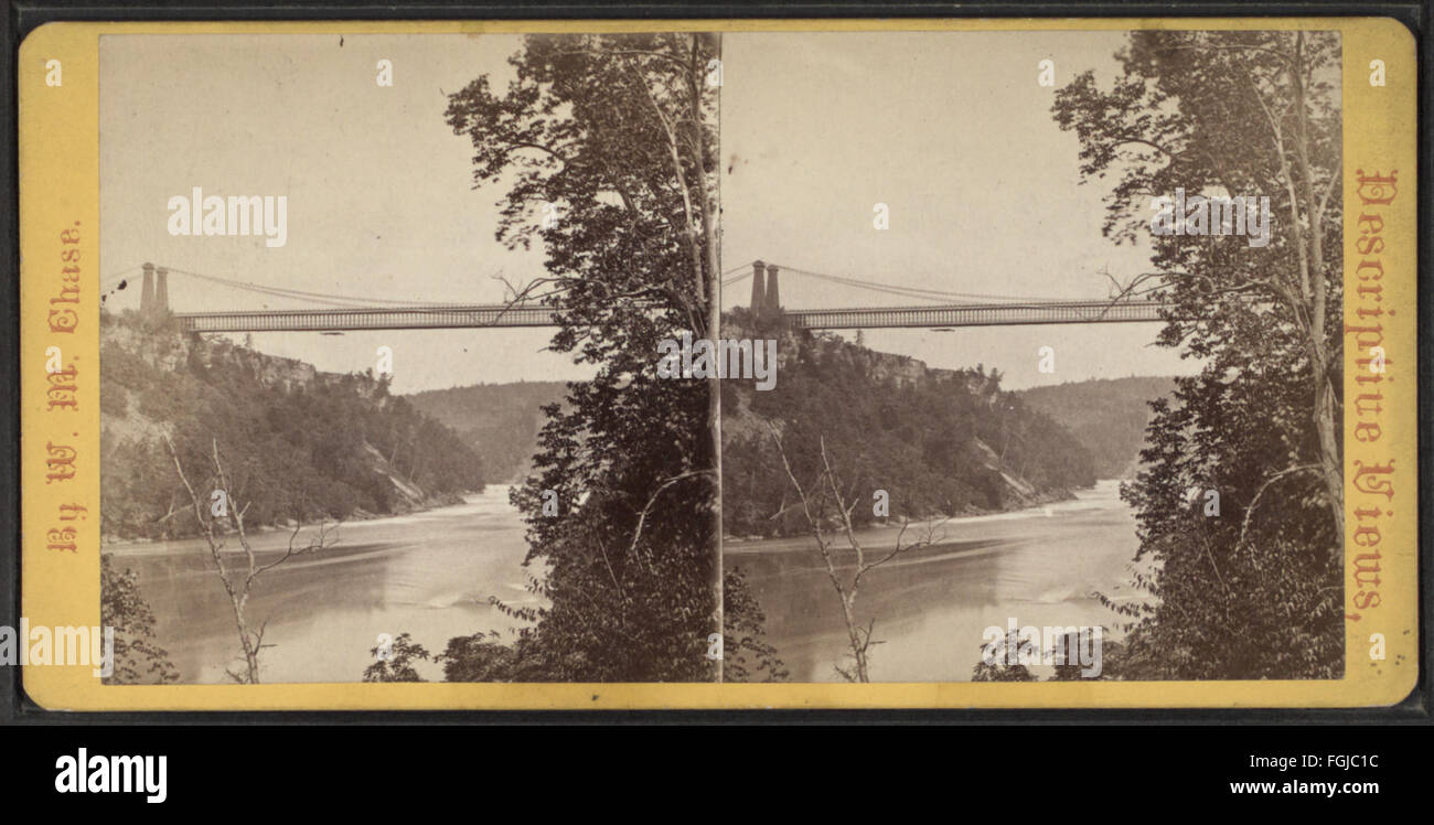 A photograph by William M. Chase showing a railroad suspension bridge ...