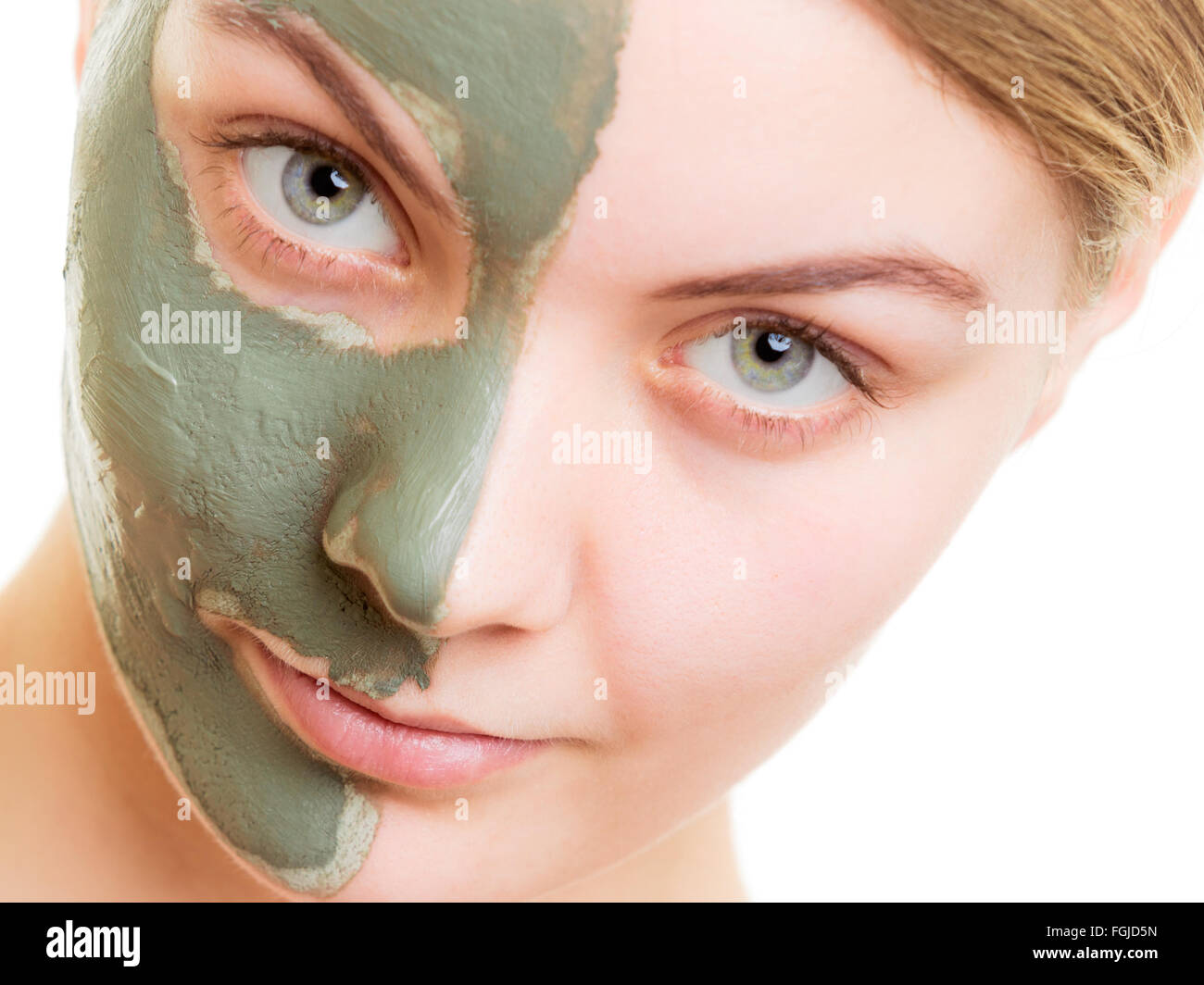 Skin care. Woman in clay mud mask on face isolated on white. Girl ...