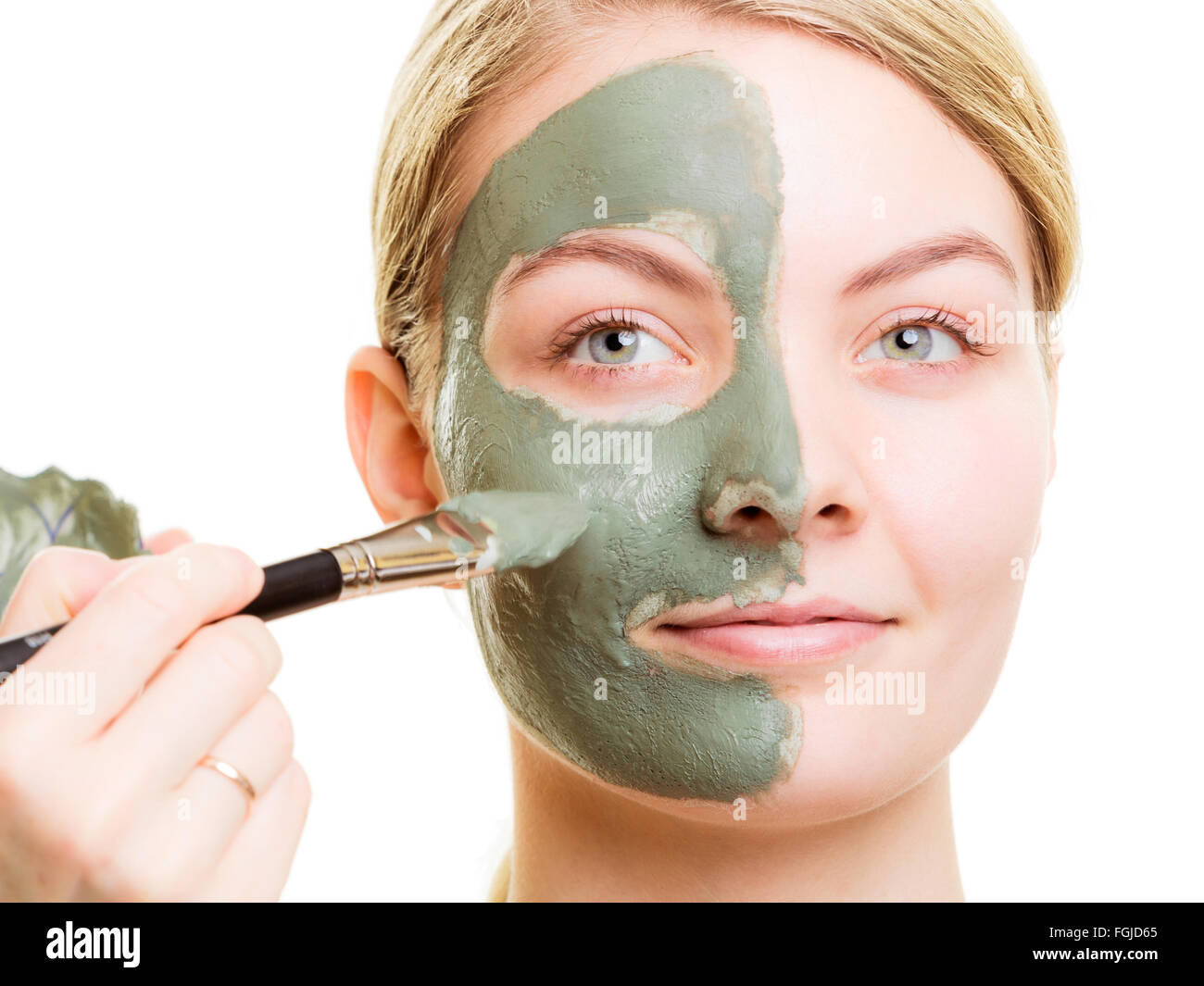 Beauty treatment concept. Cosmetician applying clay facial mask at ...