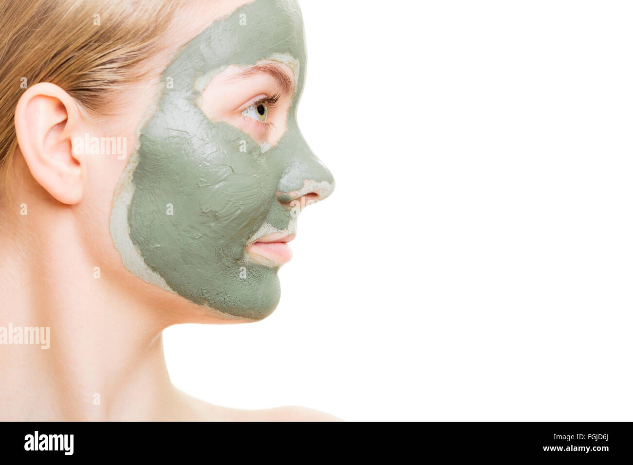 Skin care. Woman in clay mud mask on face isolated on white. Girl ...