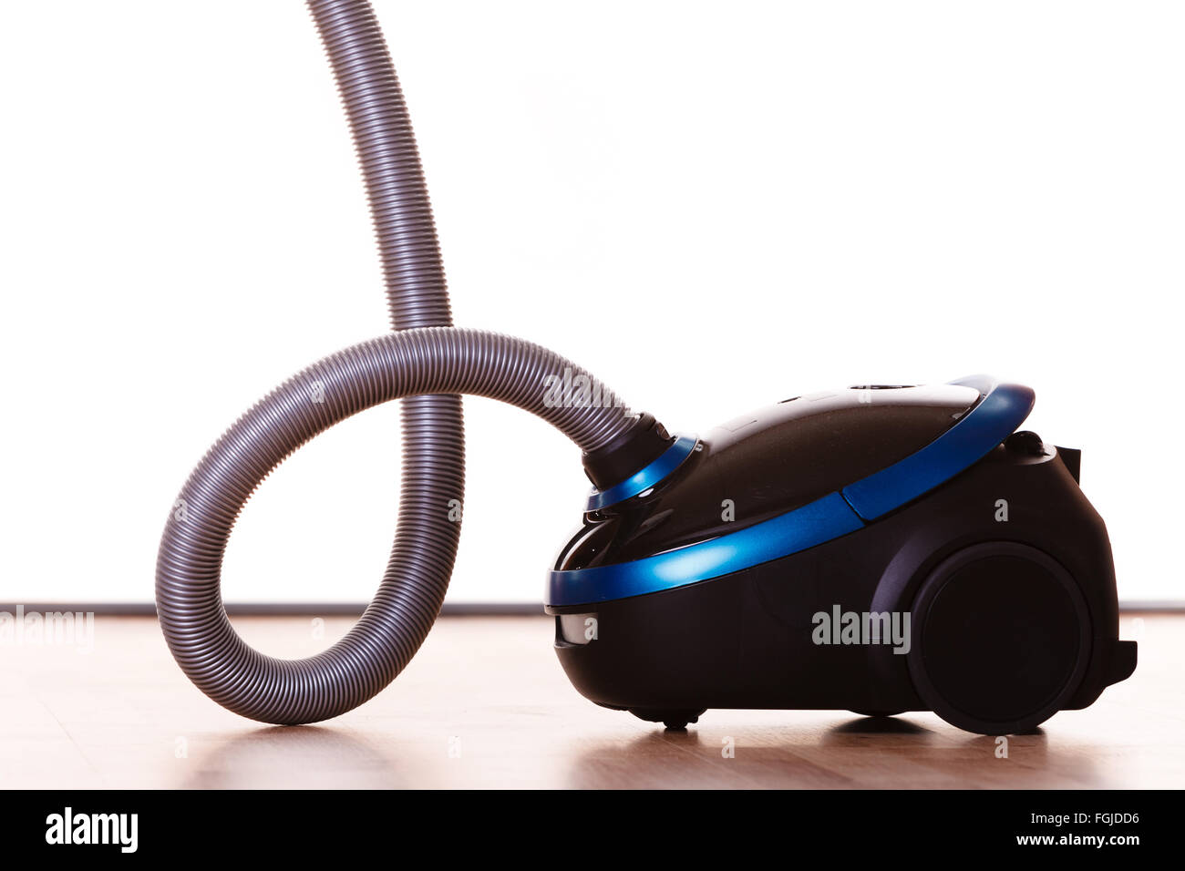 Vacuuming the house. Vacuum cleaner on wooden floor. Housework Stock ...