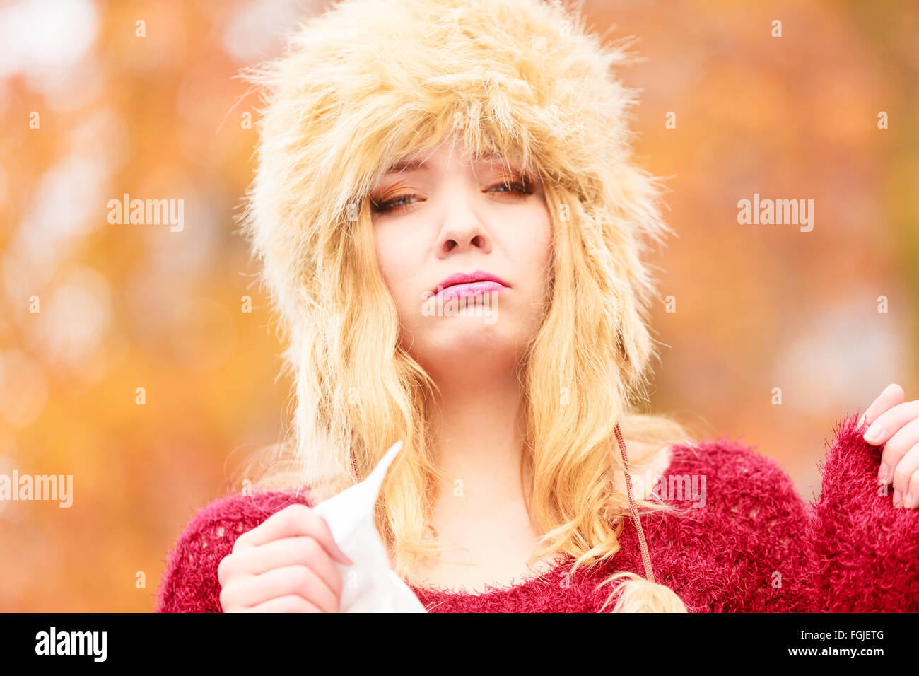Sick ill young woman girl in fall autumn forest park sneezing into ...