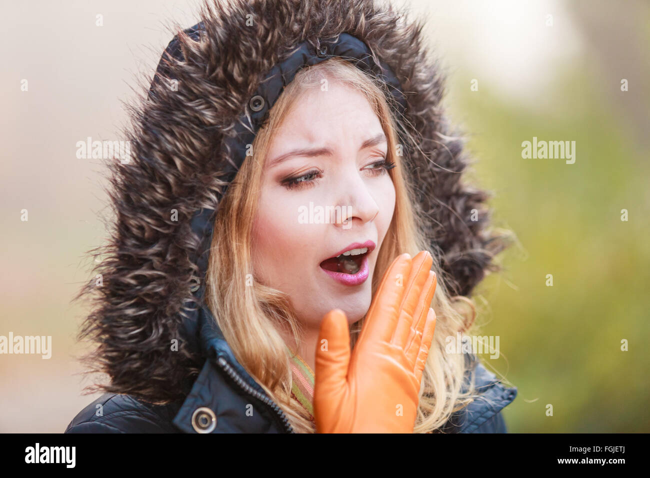 Tired exhausted young woman girl in hooded jacket yawning Stock Photo ...