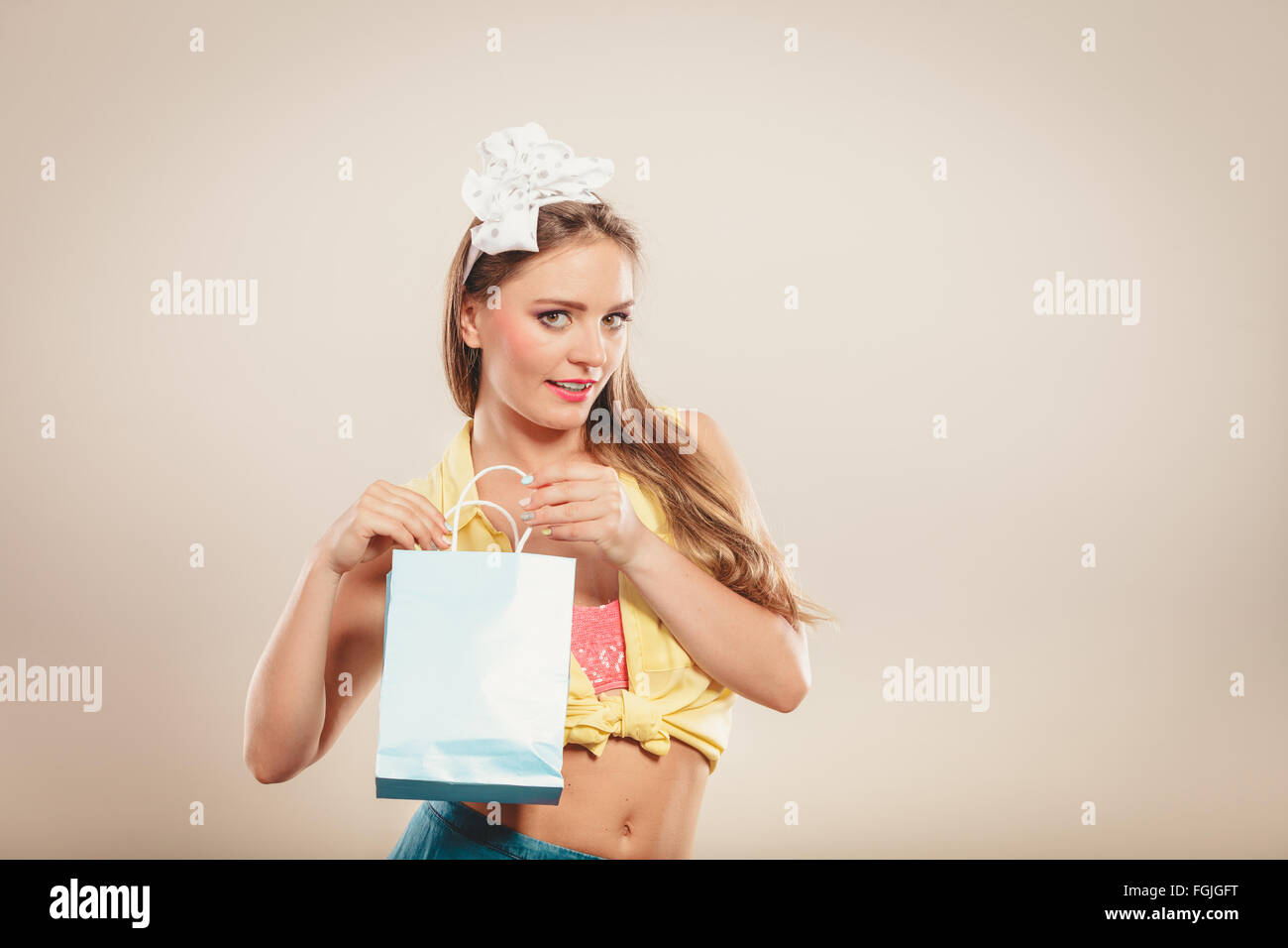Retro pin up girl shopping. Woman holding paper bag Stock Photo - Alamy