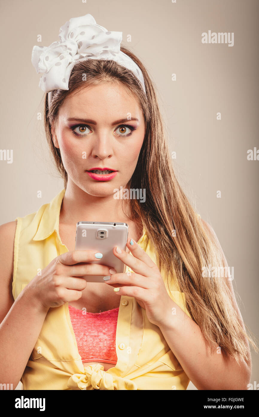 Retro pin up girl texting on mobile phone. Woman reading message Stock ...