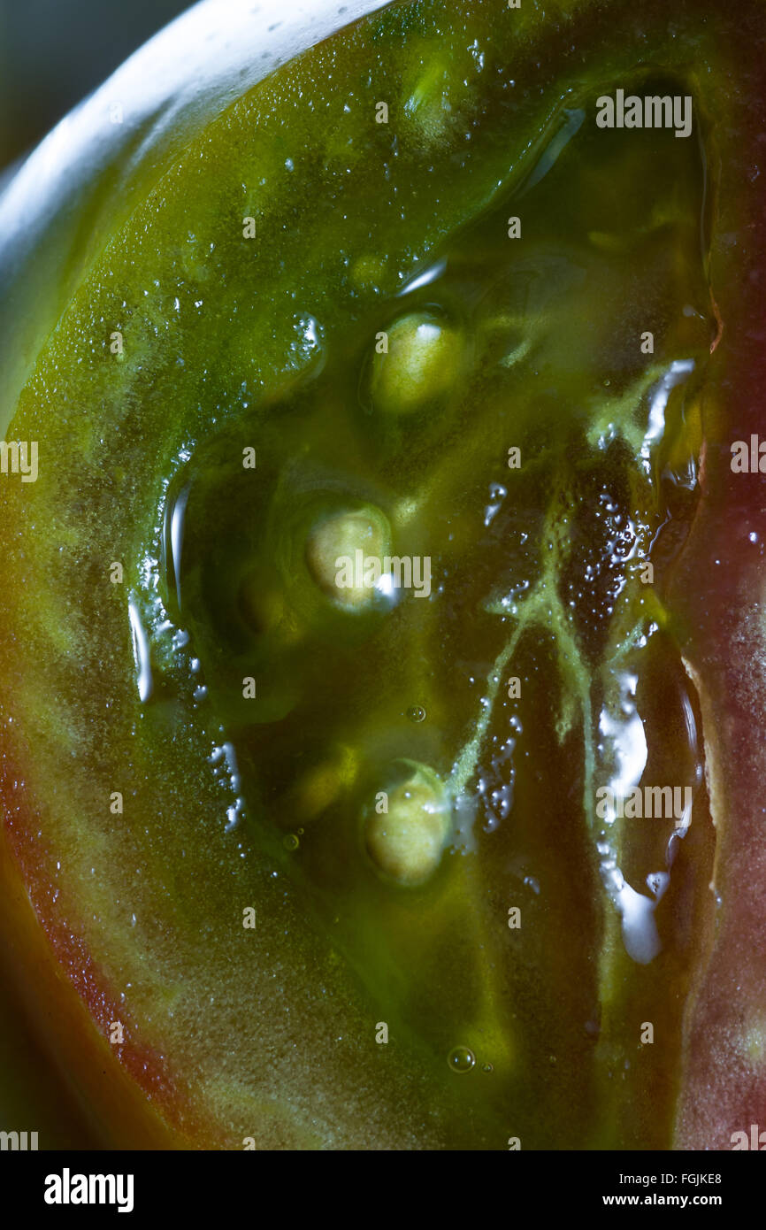 beautiful flavorful tomato cut in half with a colorful pattern and ...