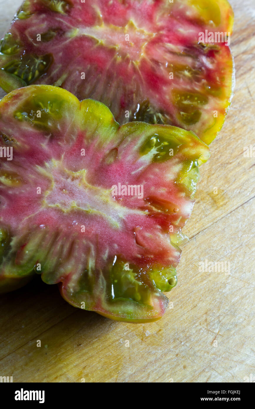 beautiful flavorful tomato cut in half with a colorful pattern and ...