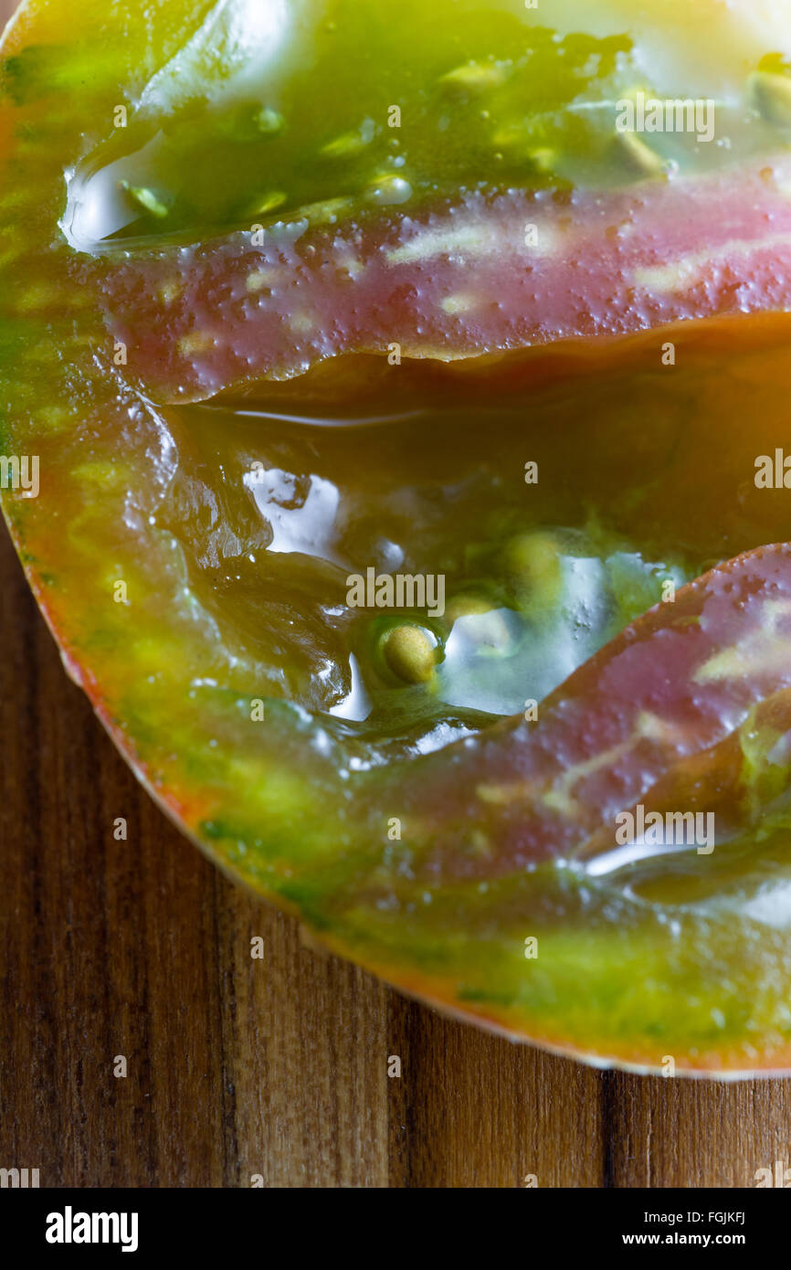 beautiful flavorful tomato cut in half with a colorful pattern and ...