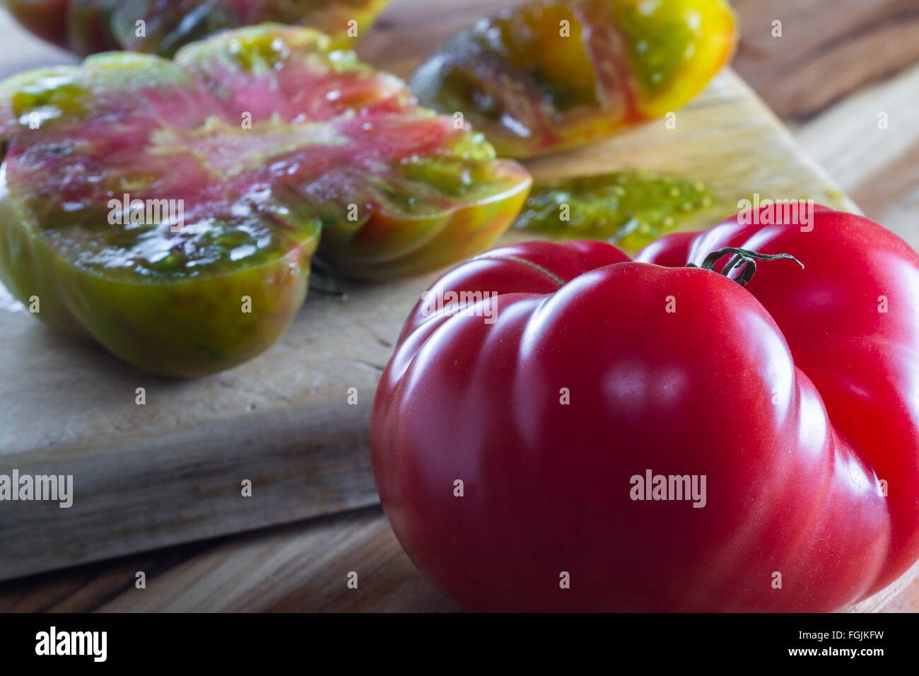 beautiful flavorful tomato cut in half with a colorful pattern and ...