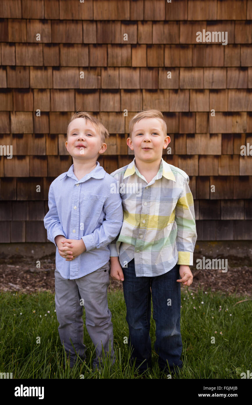 Two brothers together outdoors in a lifestyle portrait with natural ...