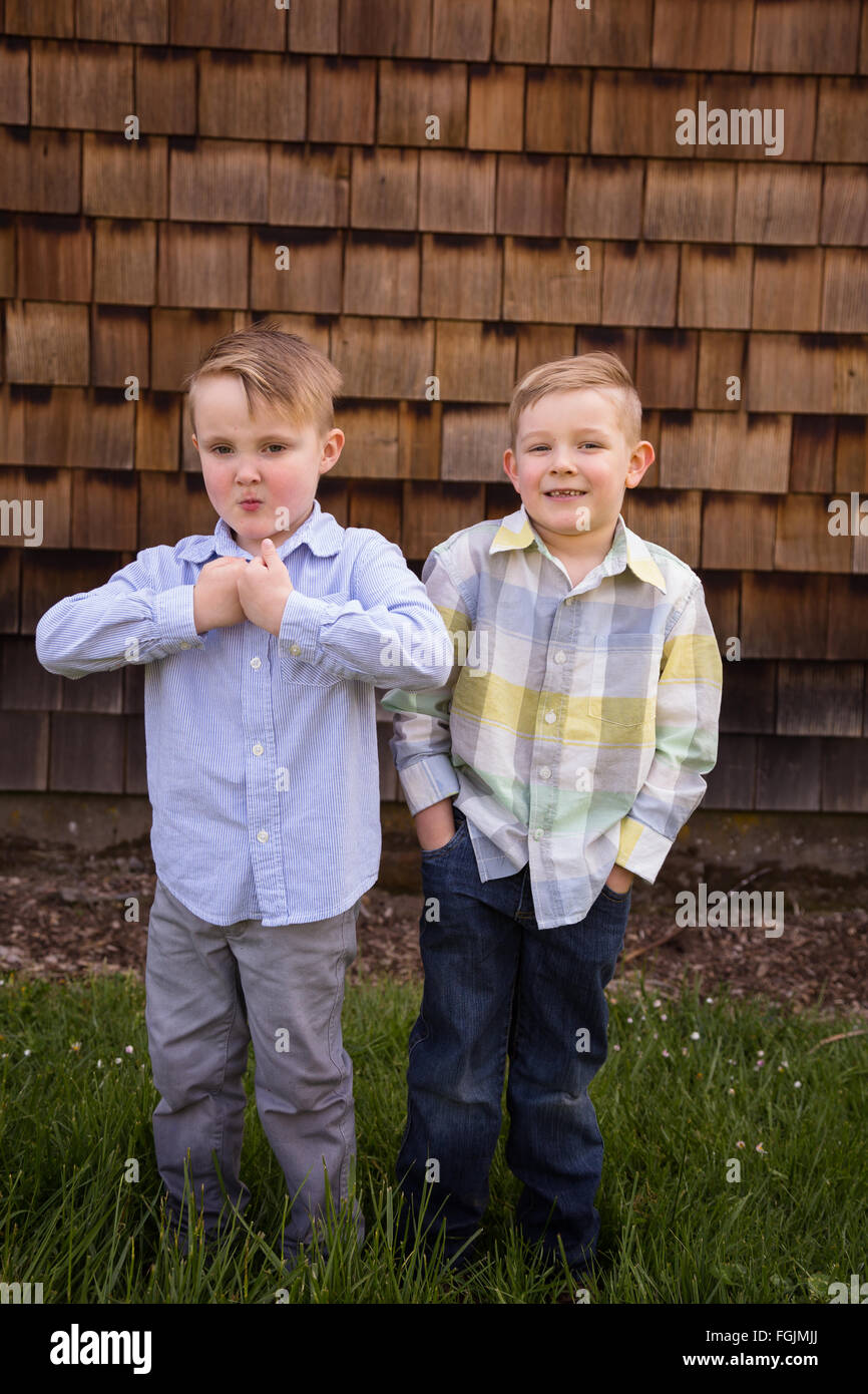 Two brothers together outdoors in a lifestyle portrait with natural ...