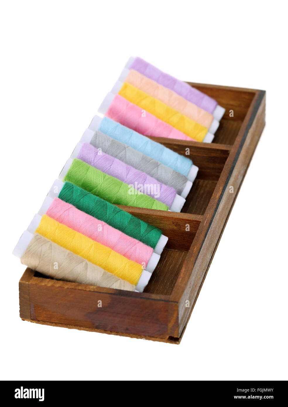 Collection of colorful threads in a wooden box isolated on white ...