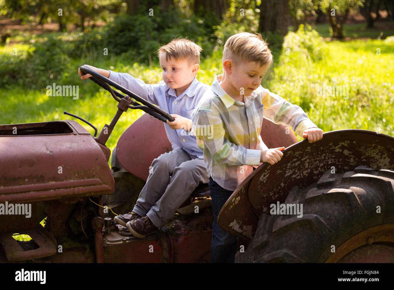 Two brothers together outdoors in a lifestyle portrait with natural ...