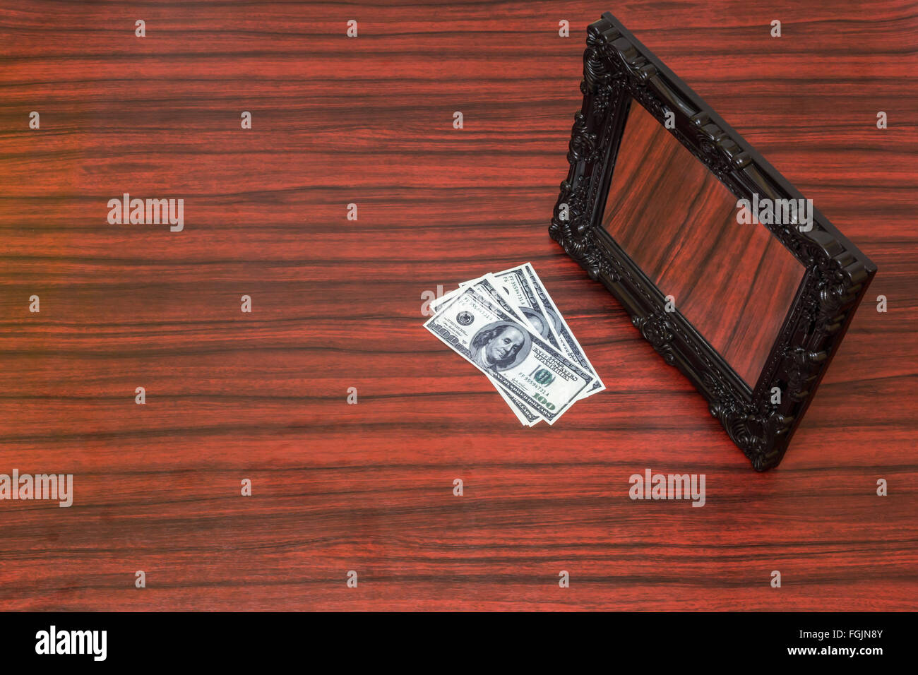 Money without reflection in the mirror on a desk Stock Photo - Alamy