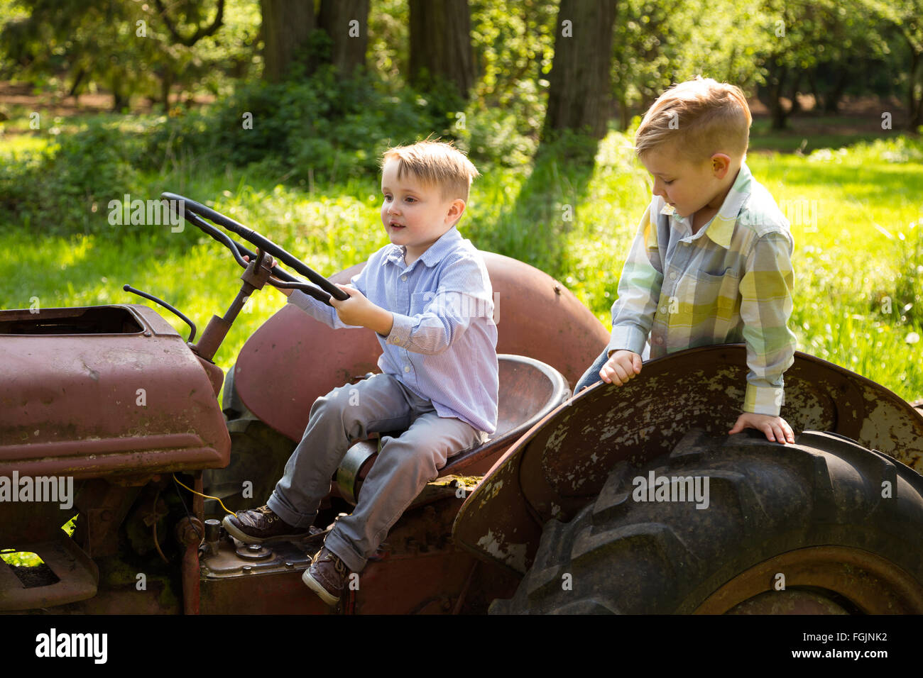 Two brothers together outdoors in a lifestyle portrait with natural ...