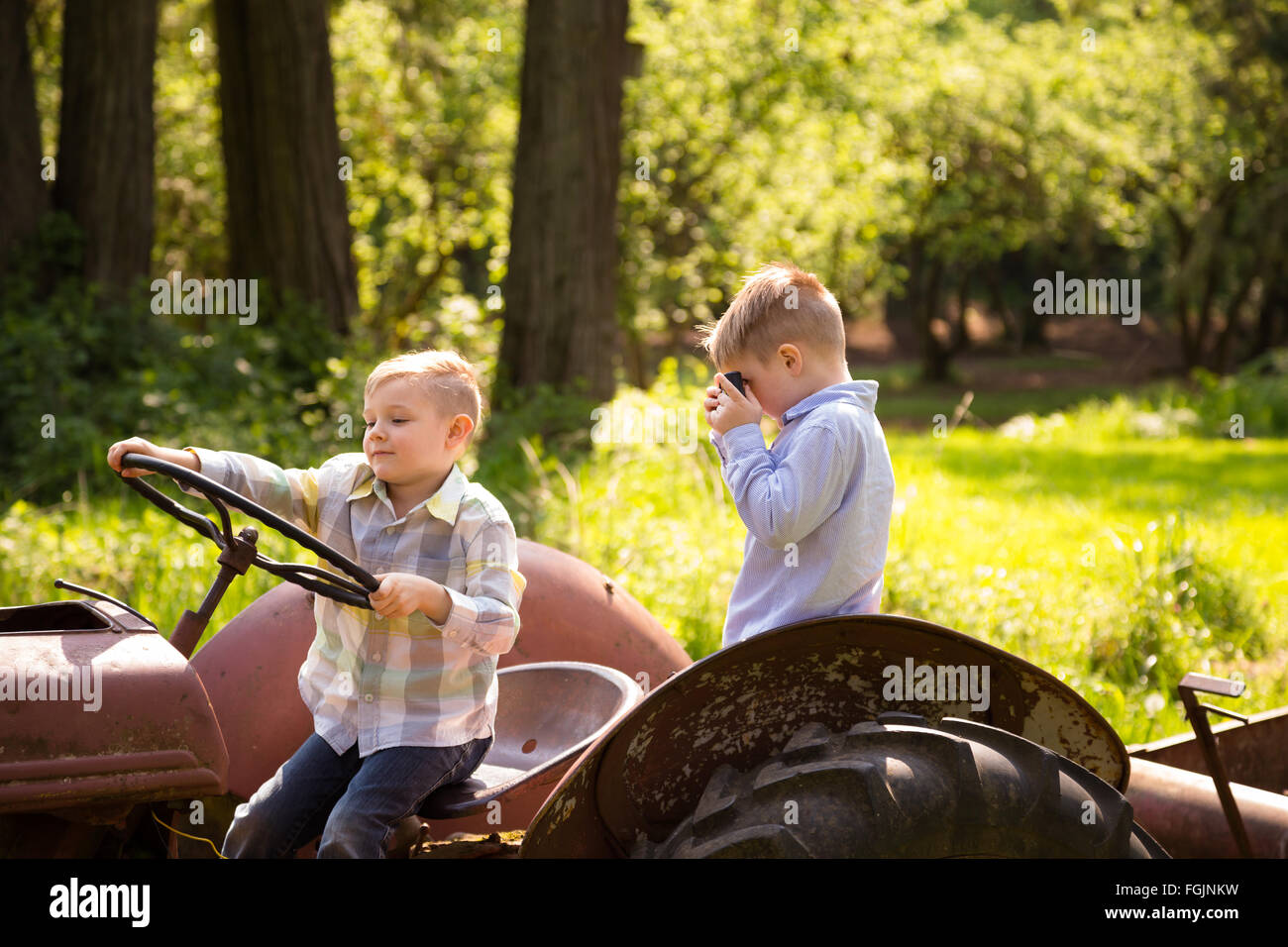 Two brothers together outdoors in a lifestyle portrait with natural ...