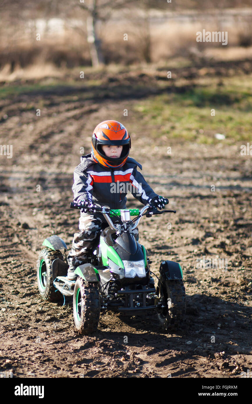 A little boy rides his electric ATV quad Stock Photo - Alamy