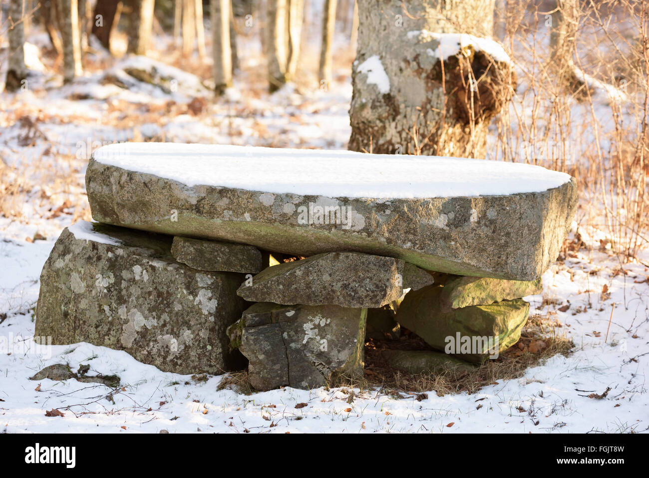A circular and flat granite boulder supported by smaller stones is used ...