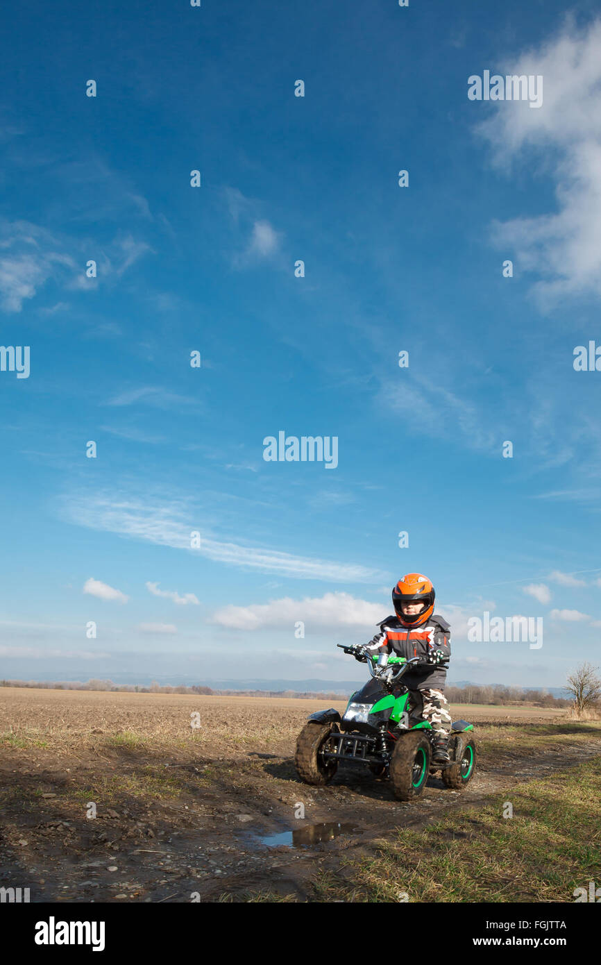 A little boy rides his electric ATV quad Stock Photo - Alamy