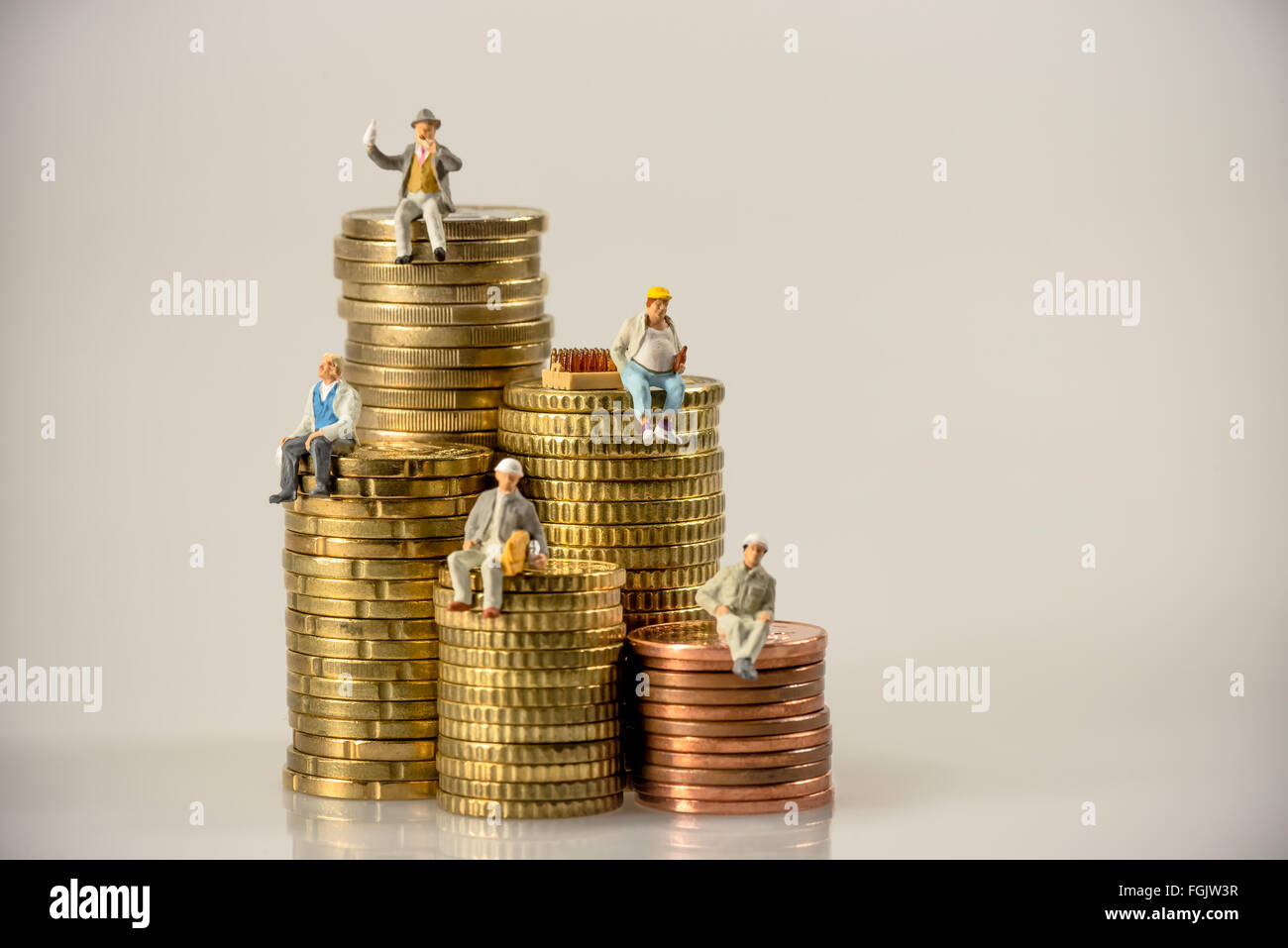 Miniature people sitting on piles hi-res stock photography and images ...