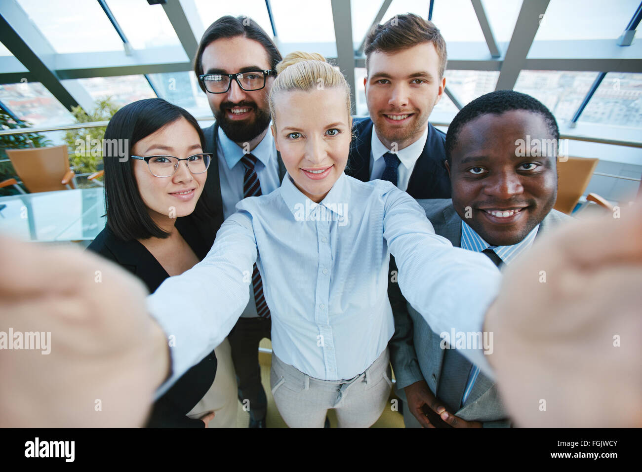 Happy young managers making selfie in office Stock Photo - Alamy
