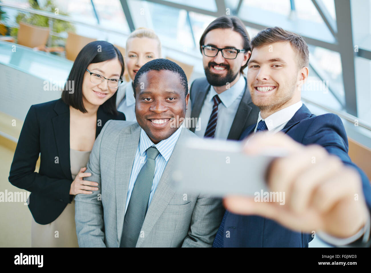Group of modern managers in formalwear making their selfie Stock Photo ...